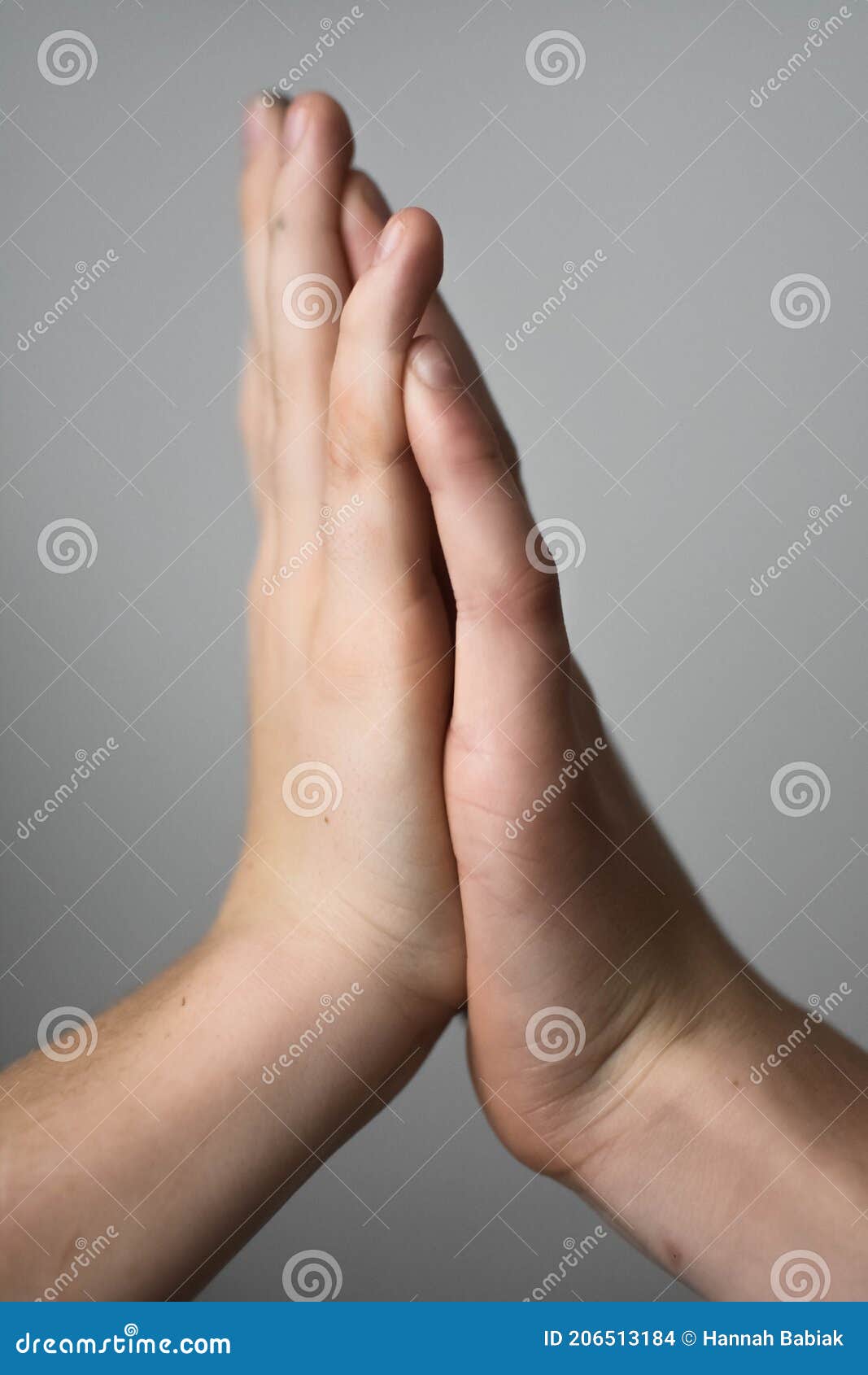 Two Hands Giving High Five stock photo. Image of high - 206513184