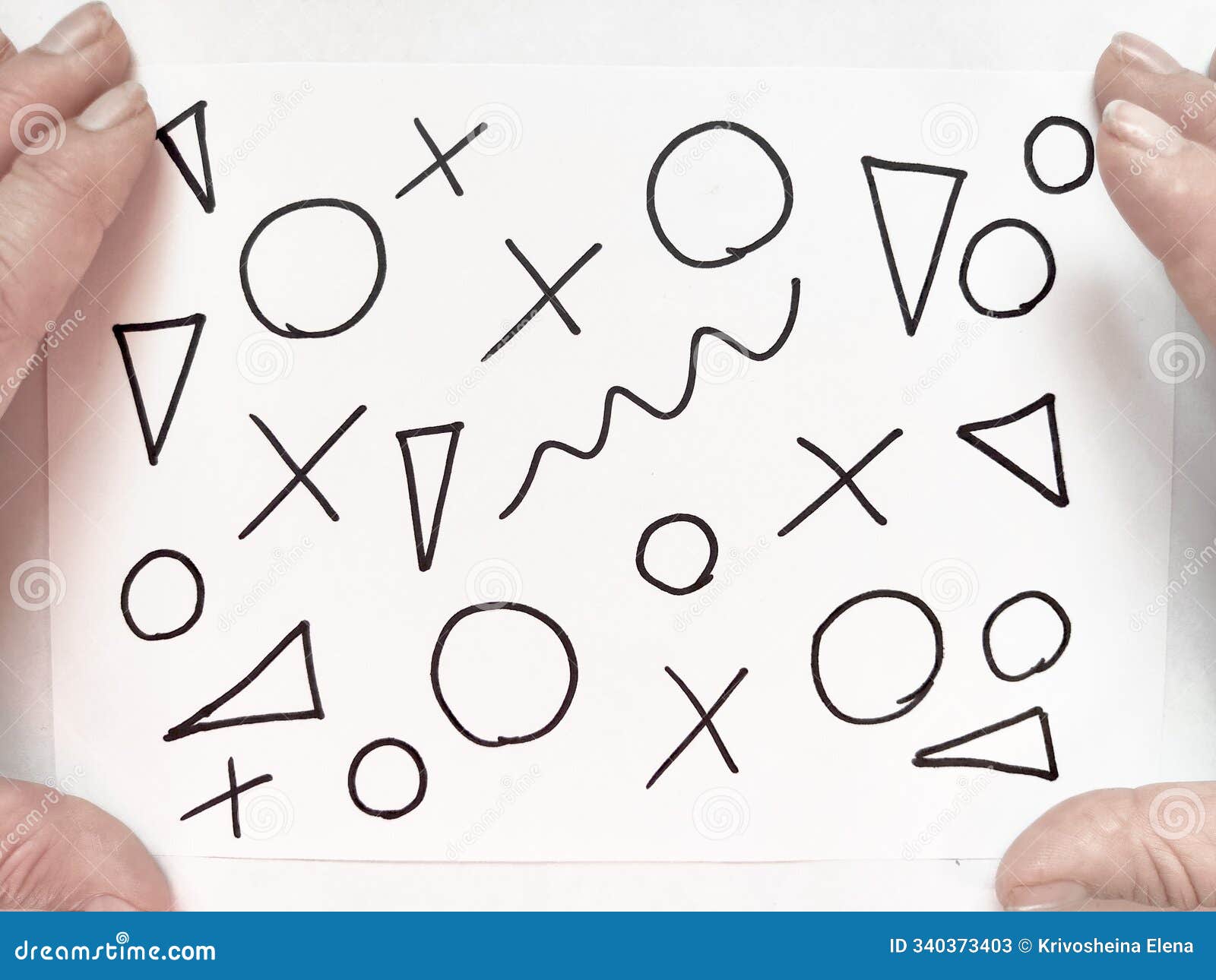 Two Hands Grasp a Card Featuring an Array of Hand-drawn Geometric ...