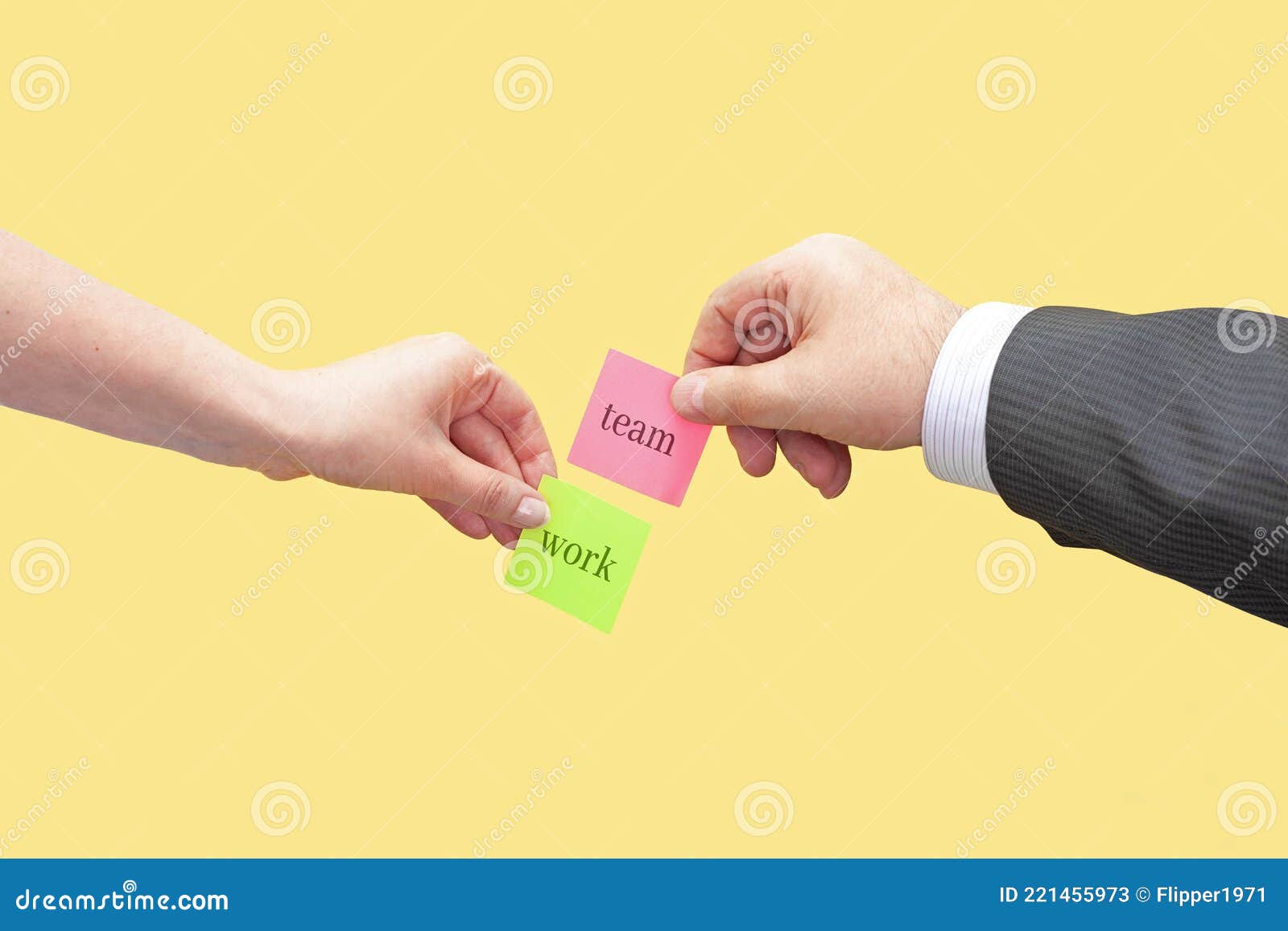 Two Hands Hold Two Sticky Notes with the Words Team and Work Stock ...