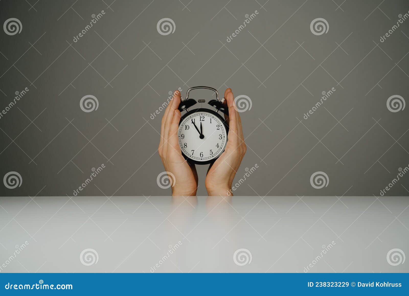 Two Hands Holding Black Clock Stock Image - Image of hour, hand: 238323229