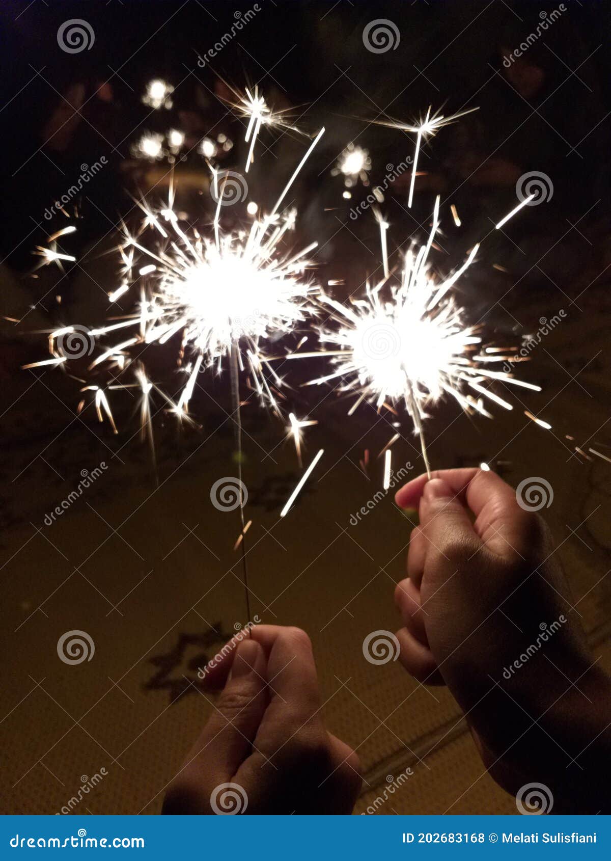 Two Hands Holding Fireworks at Night View Stock Photo - Image of light ...