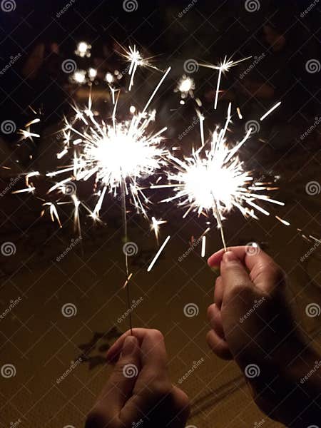 Two Hands Holding Fireworks at Night View Stock Photo - Image of light ...