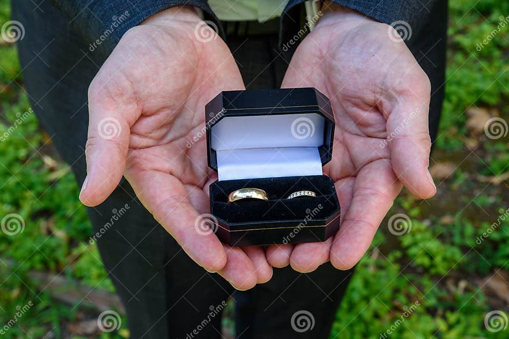 Hands Holding Wedding Rings in a Box Stock Image - Image of holding ...