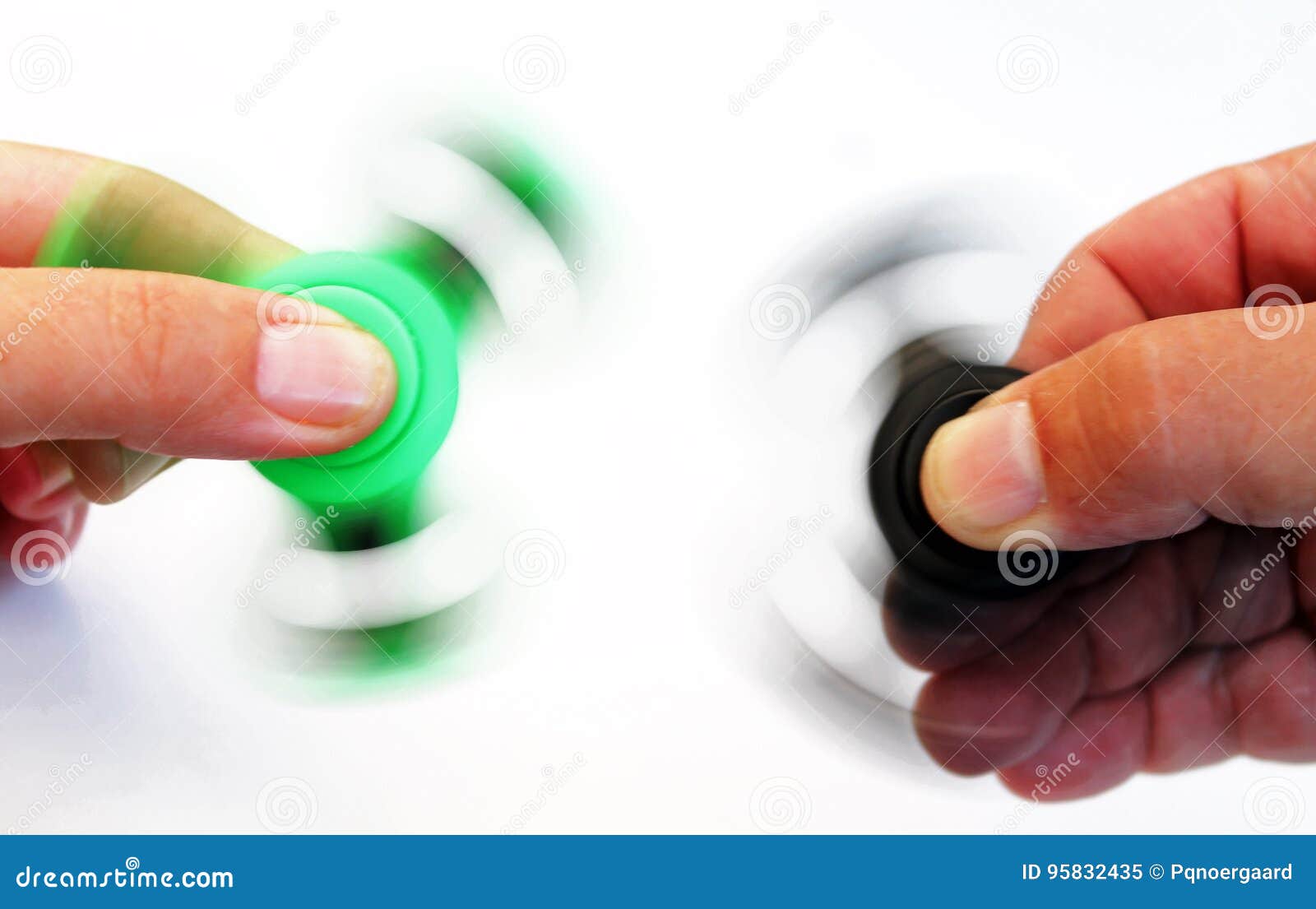 Two Hands Holding Spinning Fidget Spinners Stock Image - Image of ...