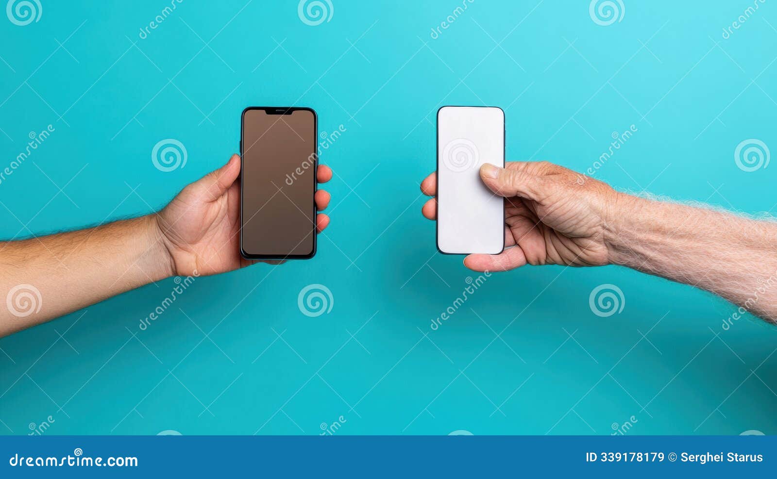 Two Hands Holding Two Different Cell Phones in Front of a Blue ... Two Hands Holding Two Different Cell Phones in Front of a Blue ...