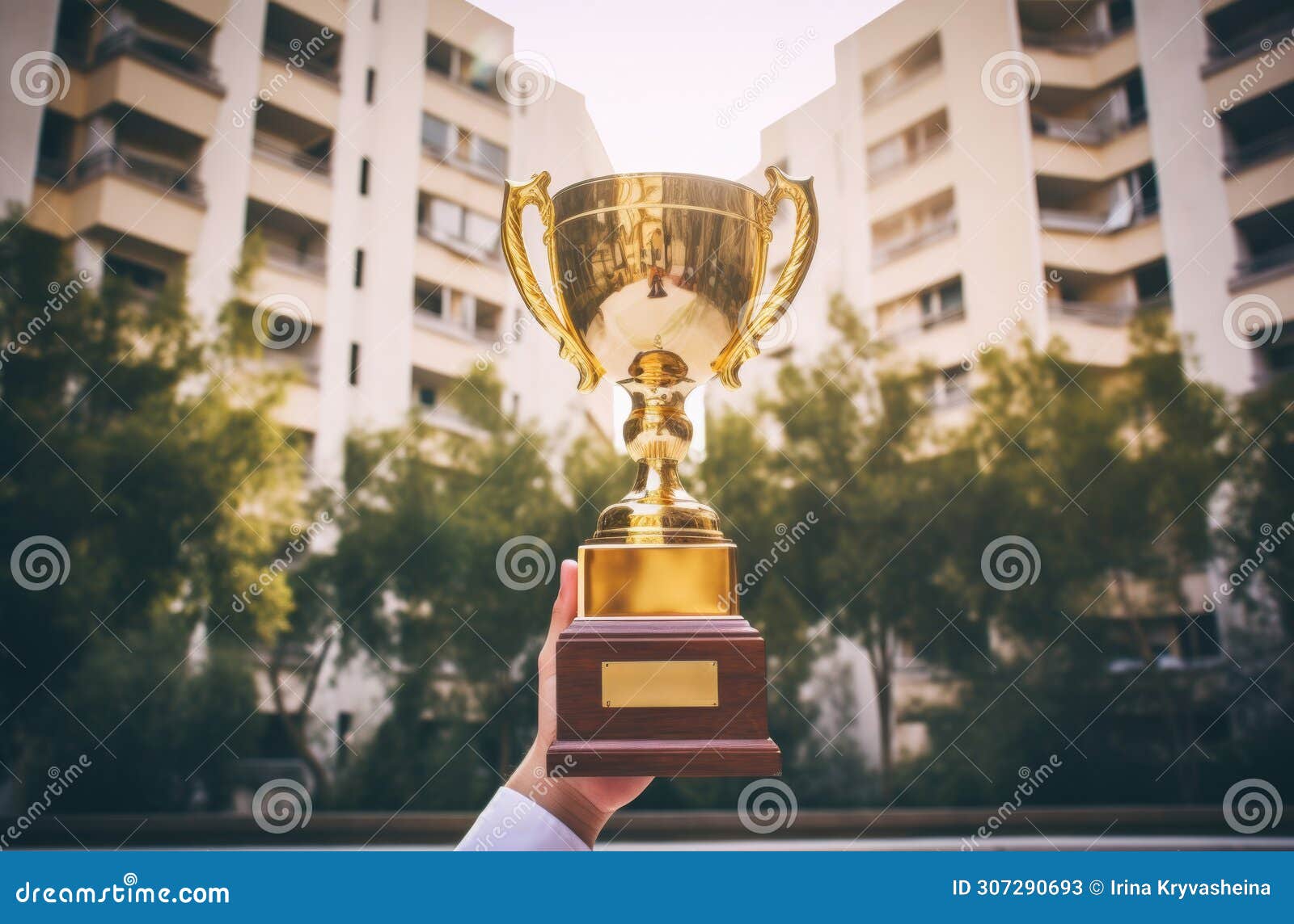 Two Hands Holding Up a Trophy in Front of an Building Stock Image ...