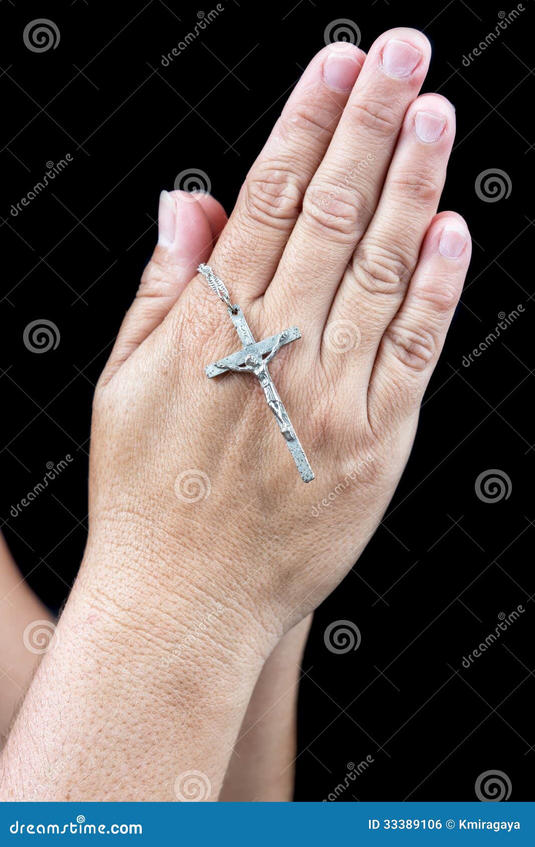 Two Hands Praying with a Small Silver Crucifix Stock Photo - Image of ...