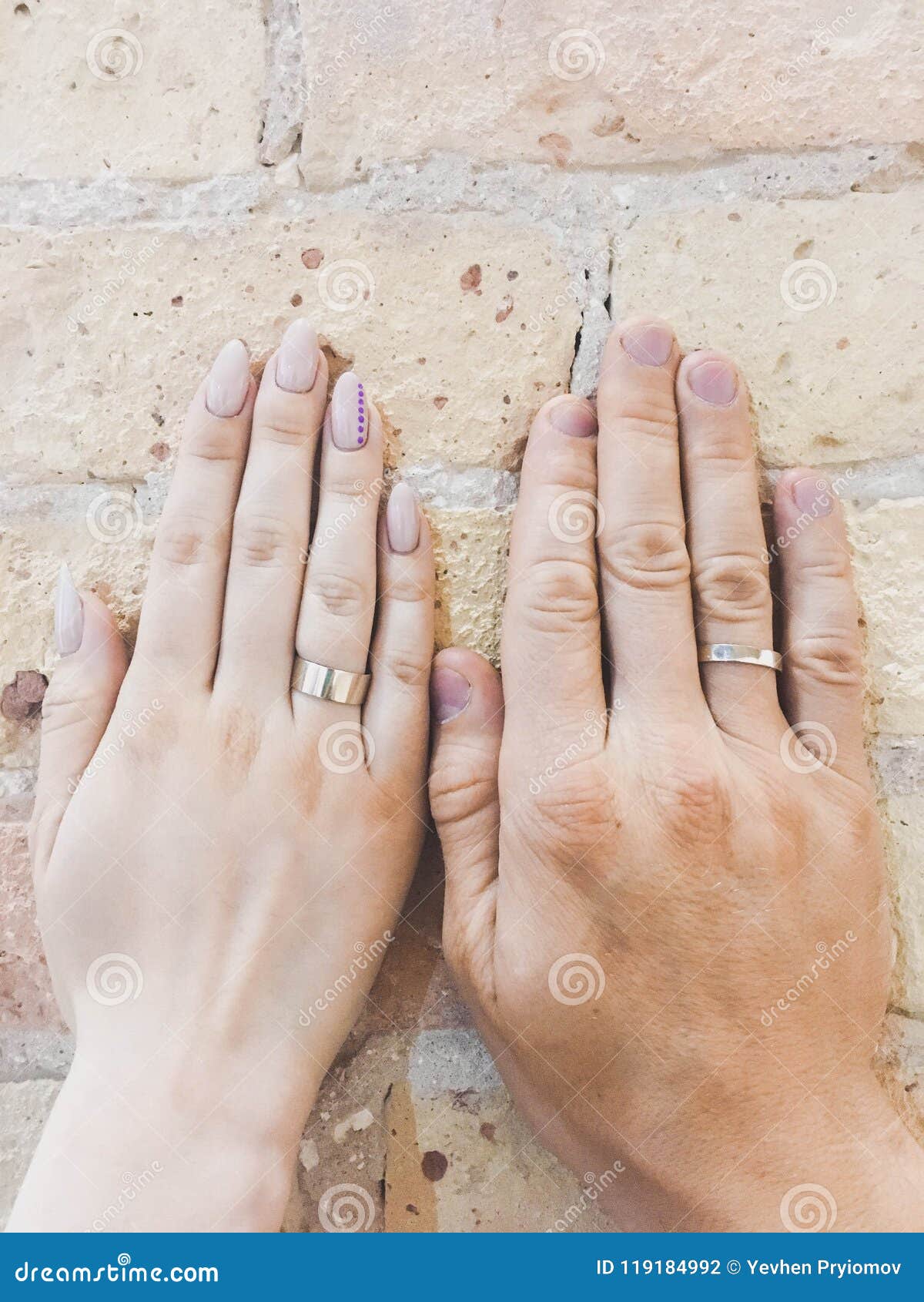 Two Hands with Rings on a Brick Wall Stock Photo - Image of young ...