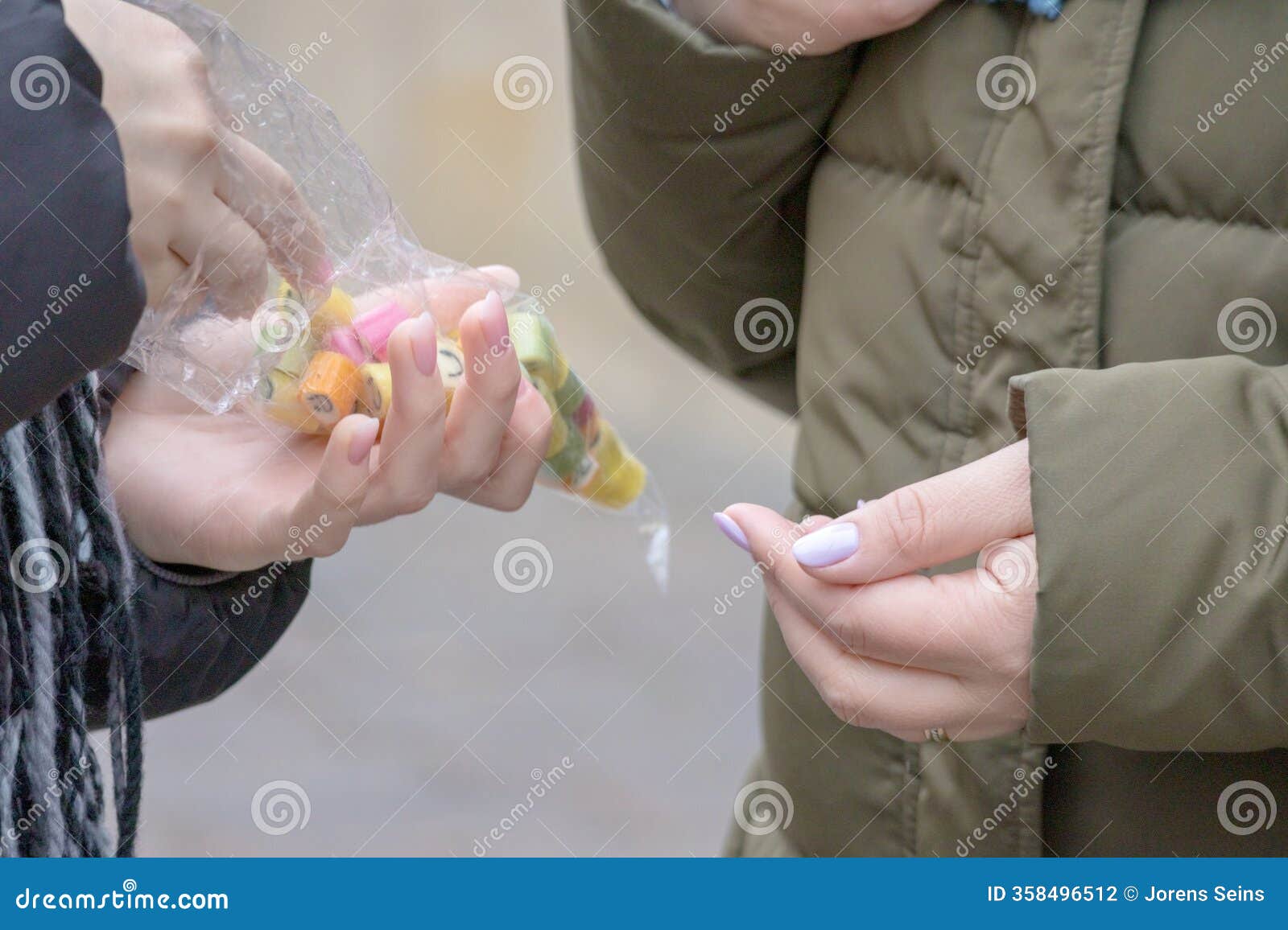 .two Hands Share Candies from a Transparent Package Stock Photo - Image ...