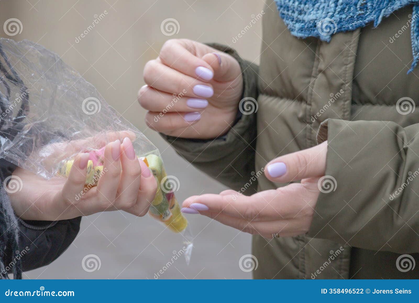 .two Hands Share Candies from a Transparent Package Stock Photo - Image ...