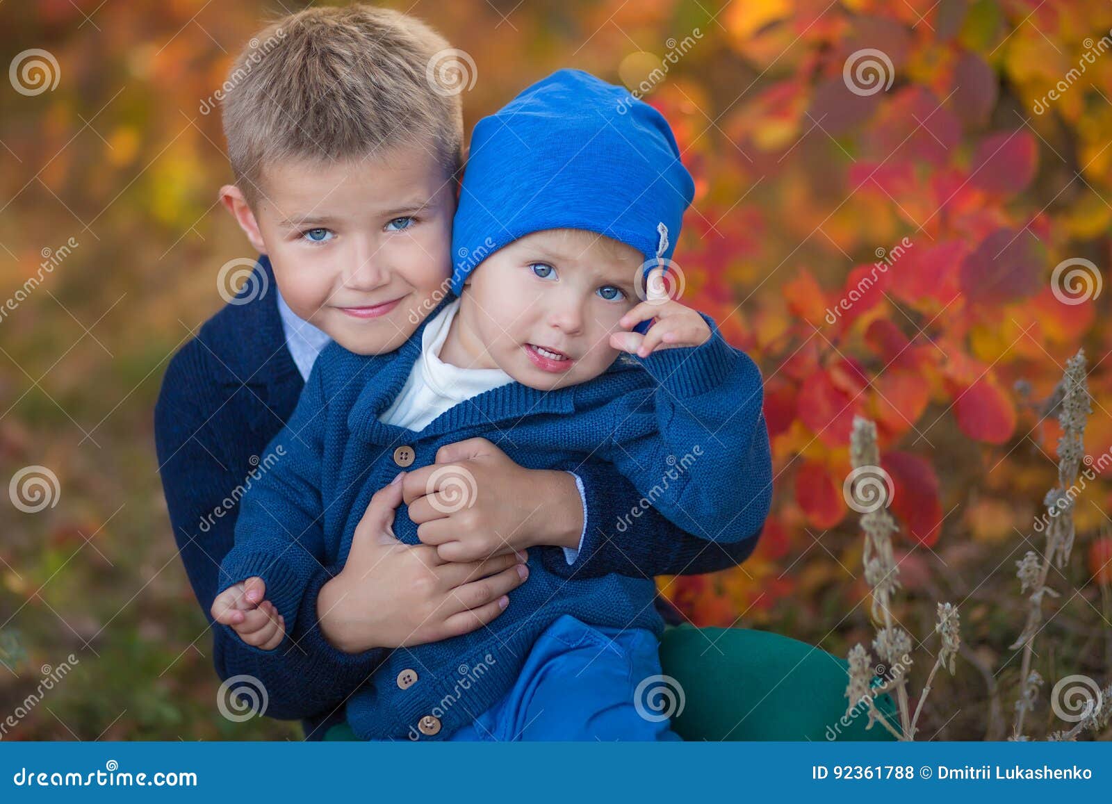 Two Handsome Cute Brothers Sitting on Pumpkin in Autumn Forest Alone ...
