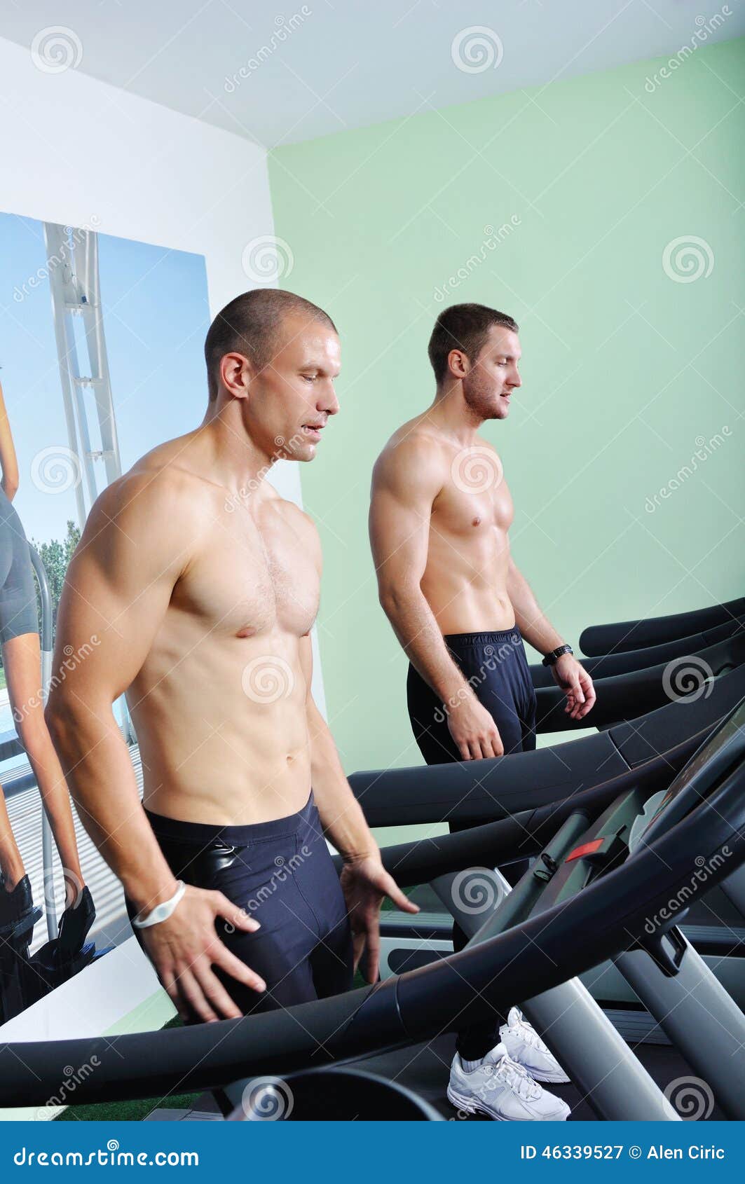 Two Handsome Men in Gym Running on the Ergometer Stock Image - Image of ...