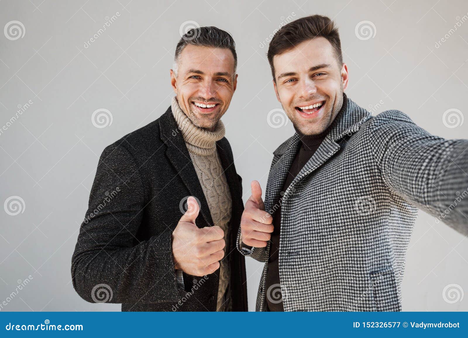 Two Handsome Men Wearing Coats Over Gray Background Stock Image - Image ...