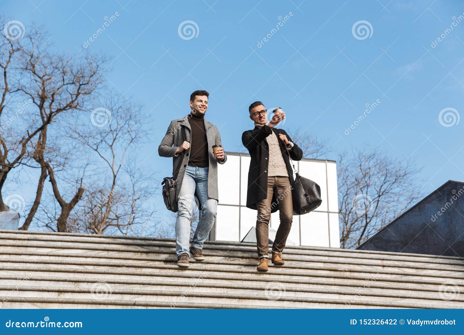 Two Handsome Men Wearing Coats Spending Time Stock Photo - Image of ...