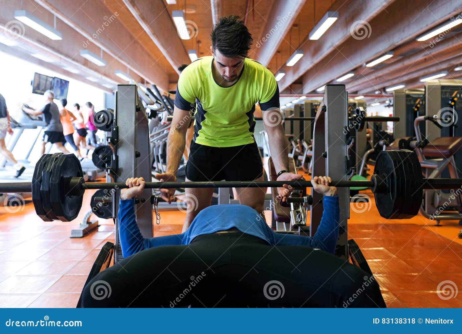 Two Handsome Young Men Doing Muscular Exercise in Gym. Stock Photo ...