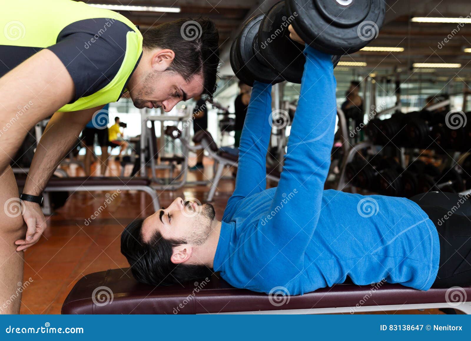 Two Handsome Young Men Doing Muscular Exercise in Gym. Stock Image ...