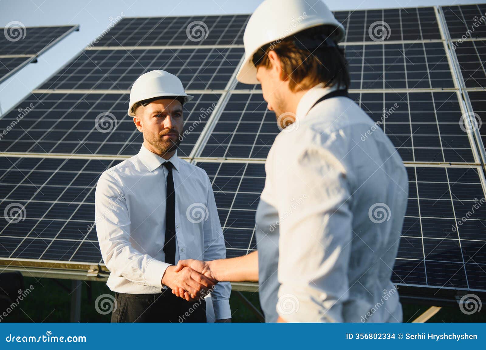 Two Happy Bearded Workers in Uniform Talking and Shaking Hands Near ...