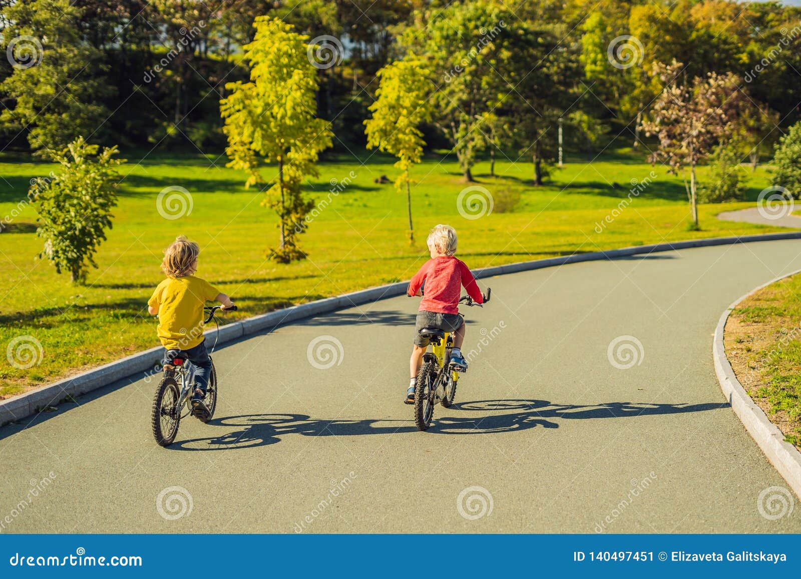 Two Happy Boys Cycling in the Park Stock Image - Image of helmet ...