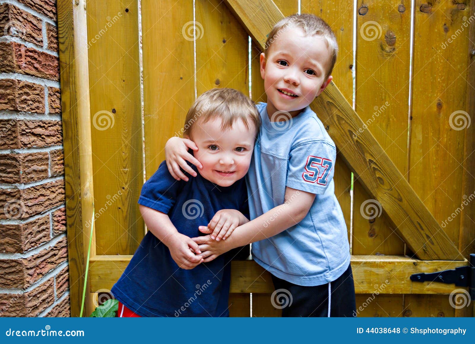 Two Happy Boys Hugging stock photo. Image of hugging - 44038648