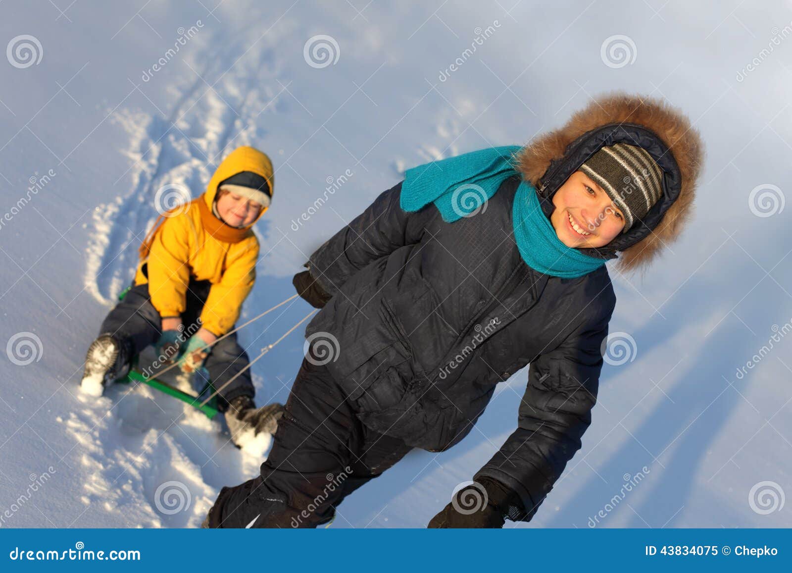 Two happy boys on sled stock image. Image of child, actions - 43834075
