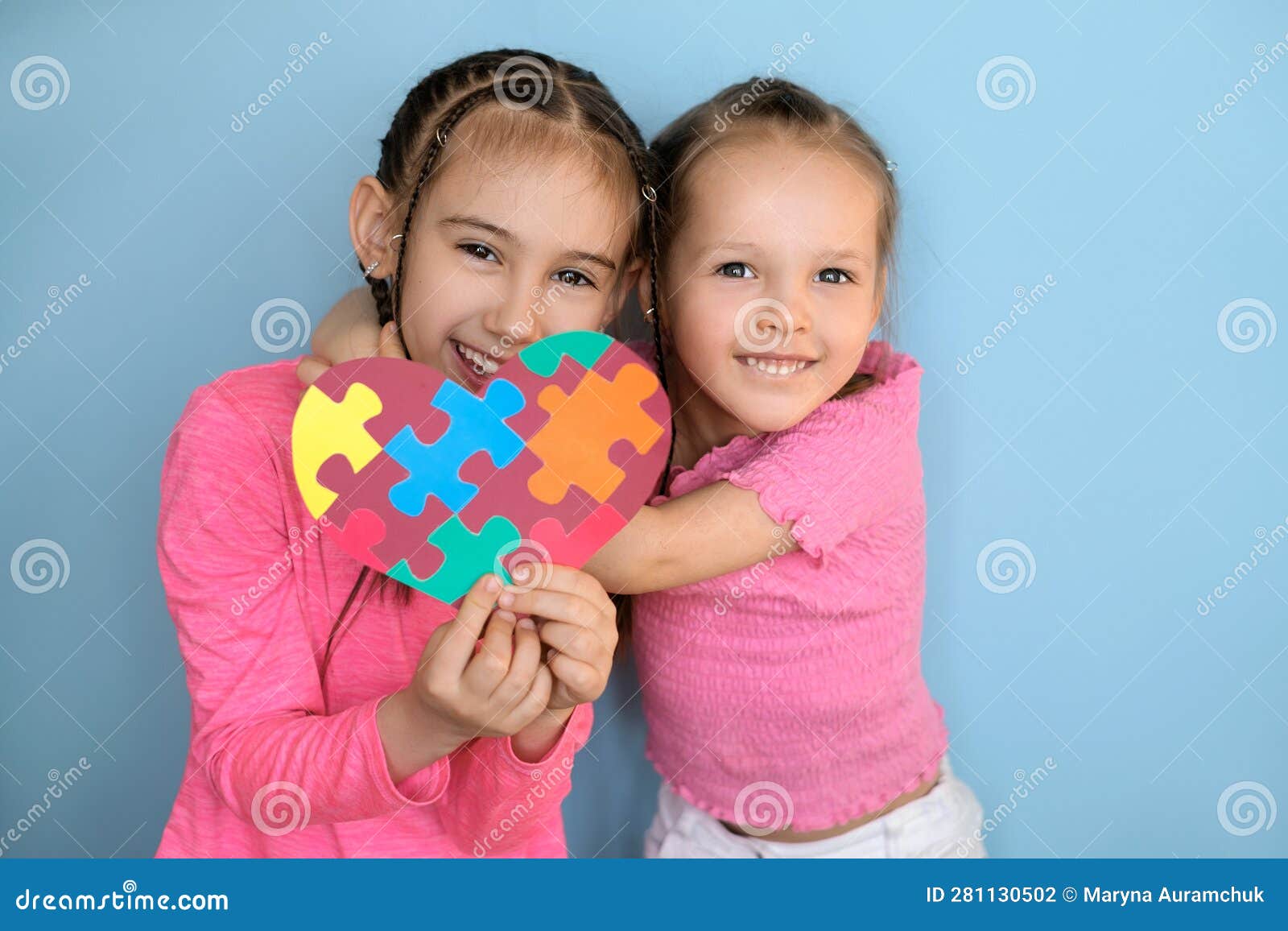 Two Happy Cheerful Sisters Show Symbol of Autism with Image of Colored ...