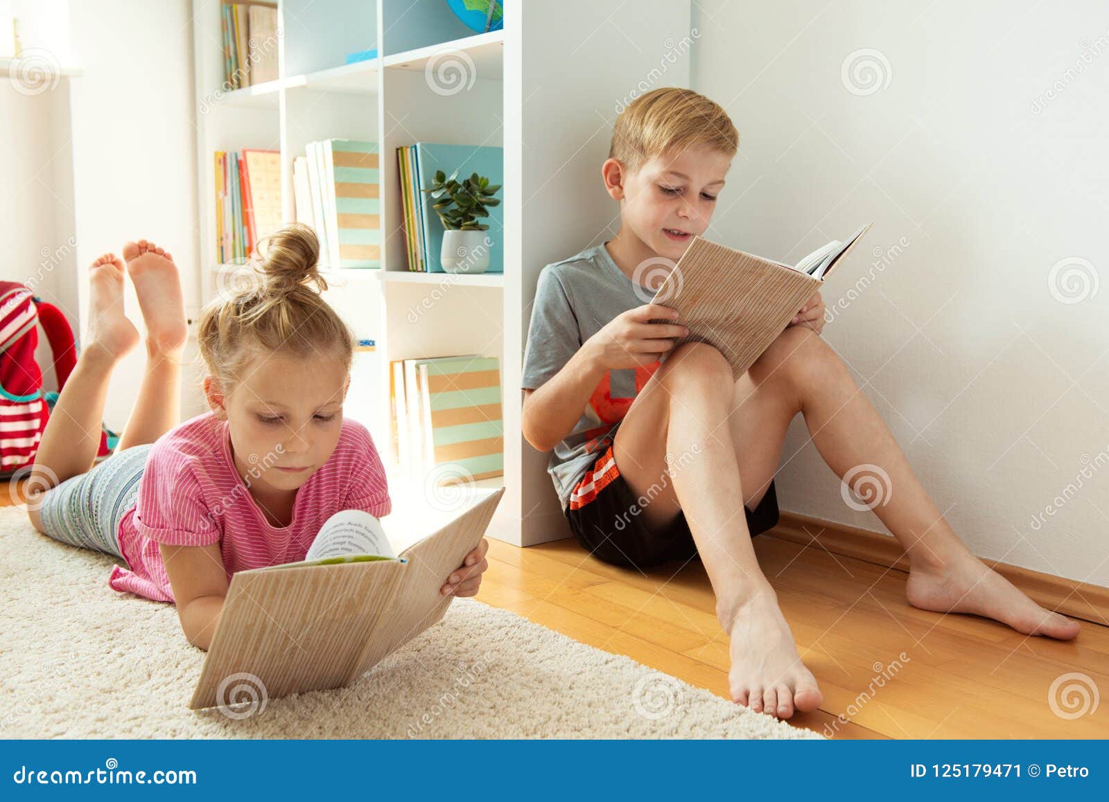 Happy Children Reading Books on the Floor at the School Library Stock ...