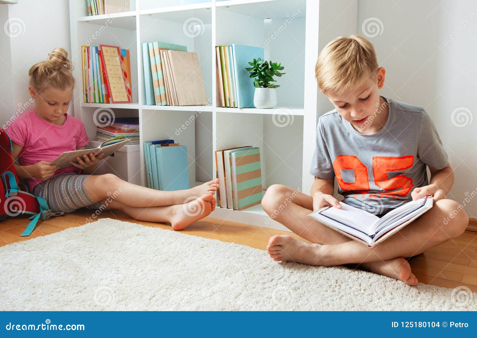 Happy Children Reading Books on the Floor at the School Library Stock ...