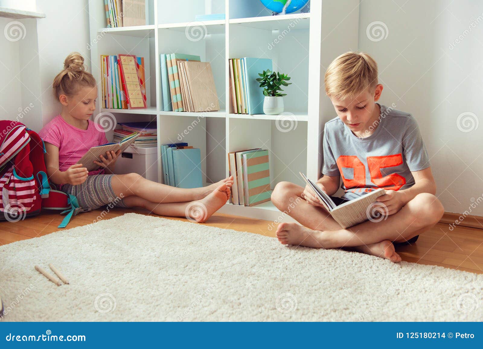 Happy Children Reading Books on the Floor at the School Library Stock ...