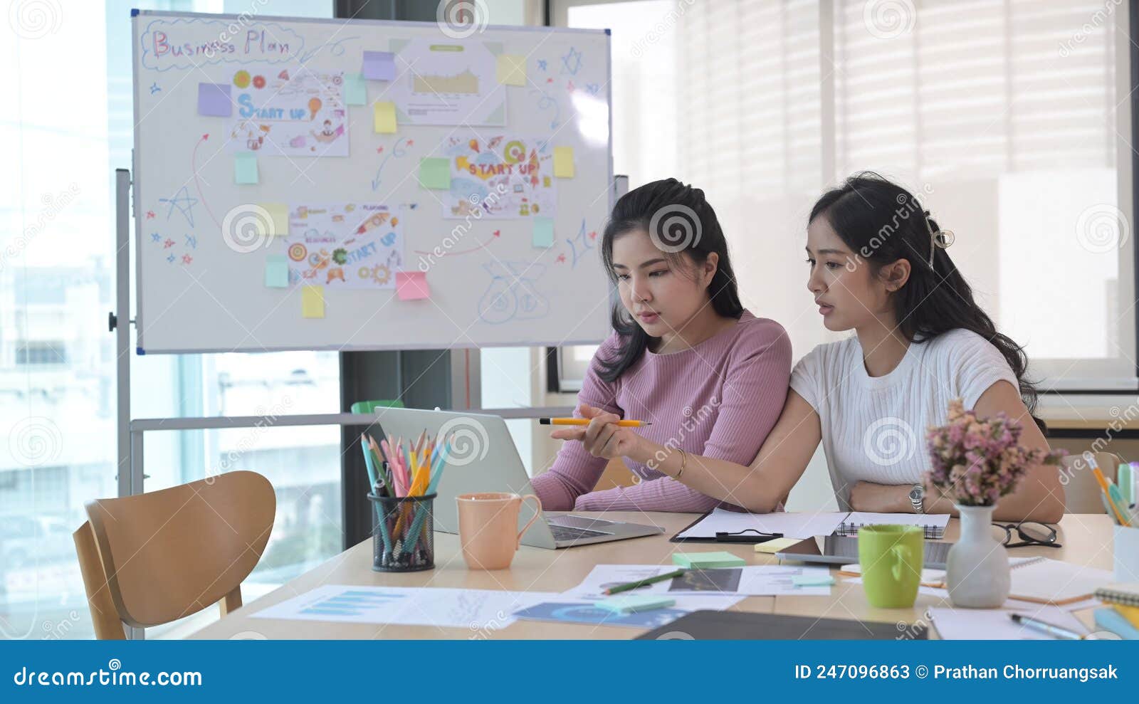 Two Colleagues Working on an Important Project Together at Creative ...