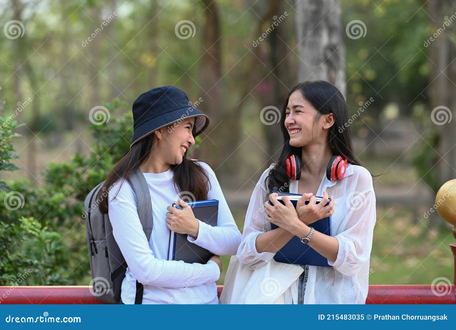 Two Happy College Student Talking and Laughing Each Other while ...