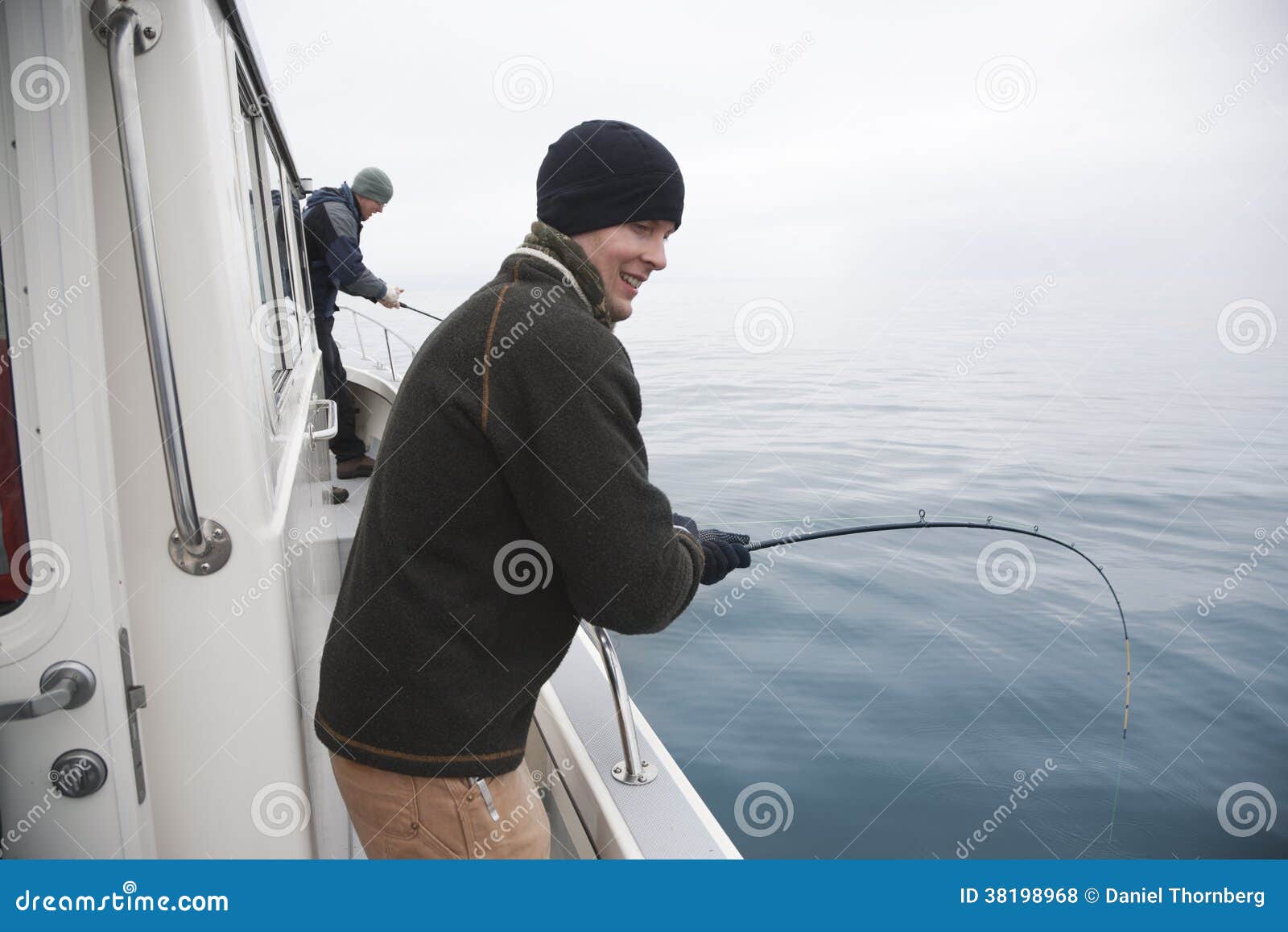 Two Happy Fisherman Catching Fish in Alaska Stock Photo - Image of boat ...