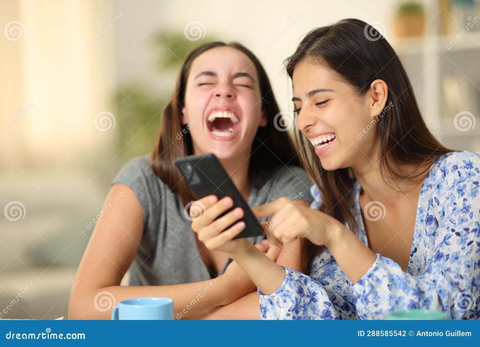 Two Happy Friends Laughing Hilarious Using Phone at Home Stock Photo ...