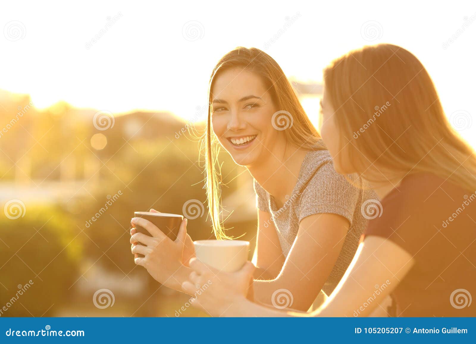 Two Happy Friends Talking in a Balcony at Sunset Stock Image - Image of ...