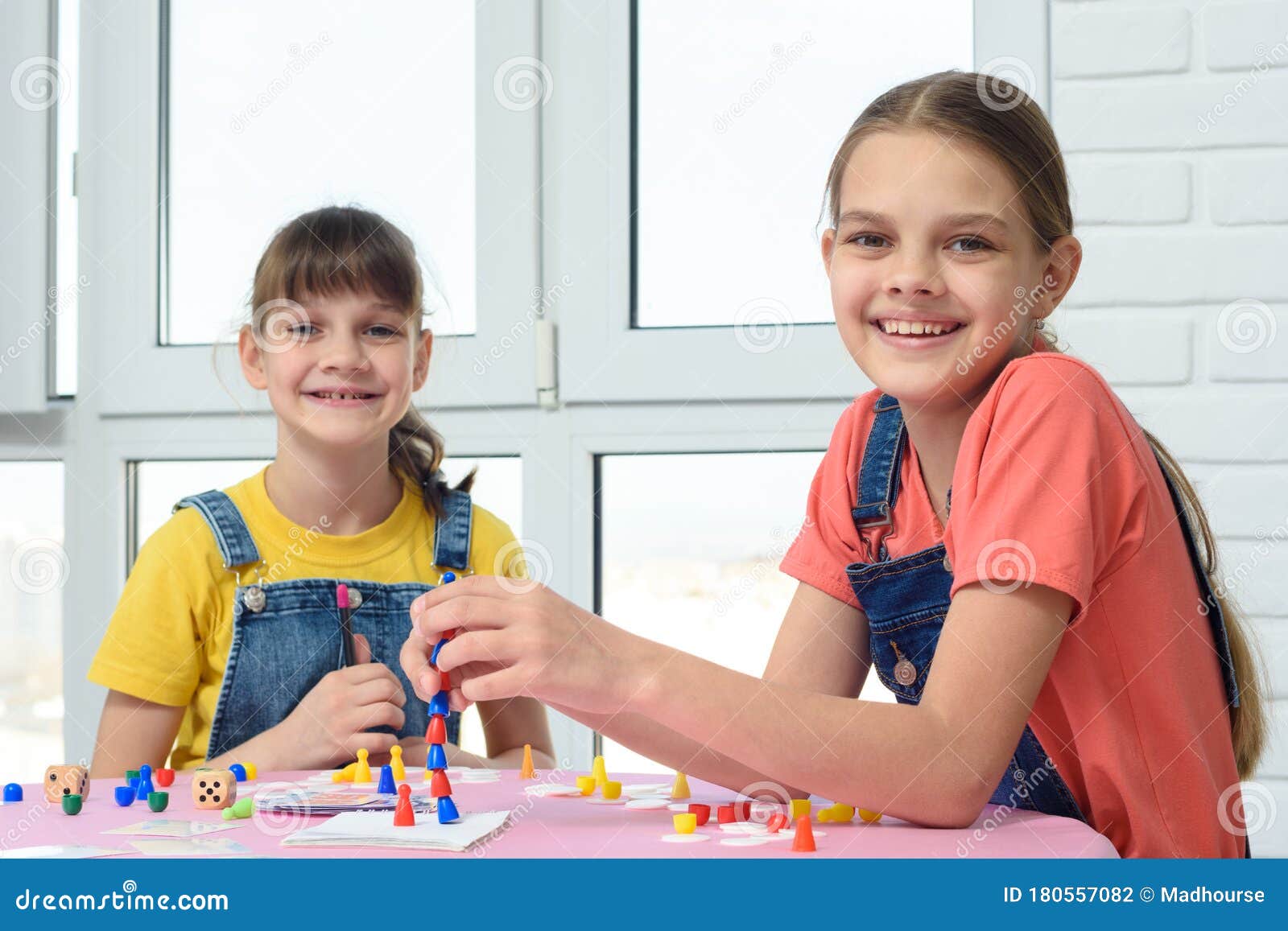 Two Happy Girls Play a Board Game and Looked at the Frame Stock Photo ...