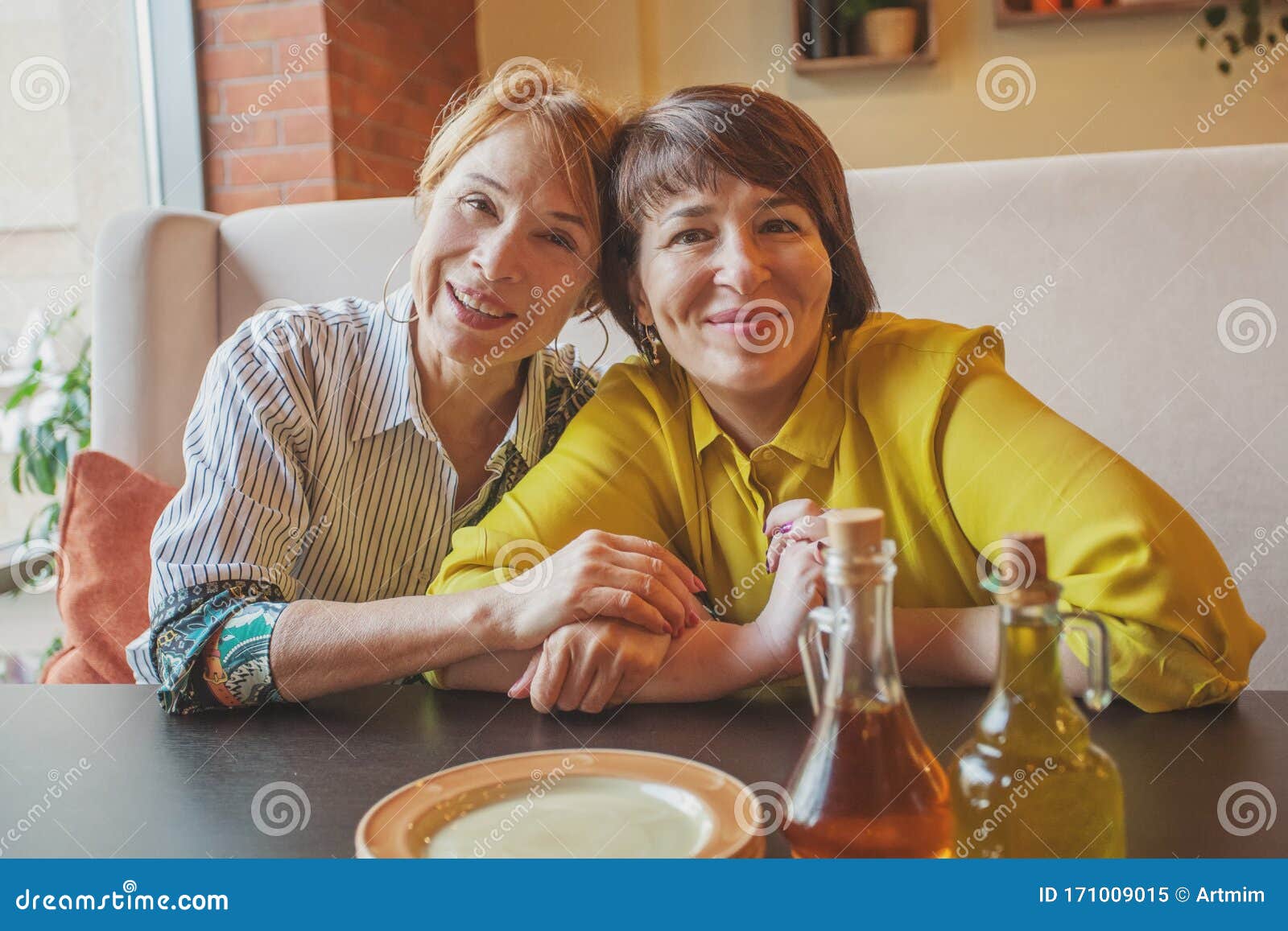 Two Mature Women Attending Art Class In Community Centre With Teacher ...