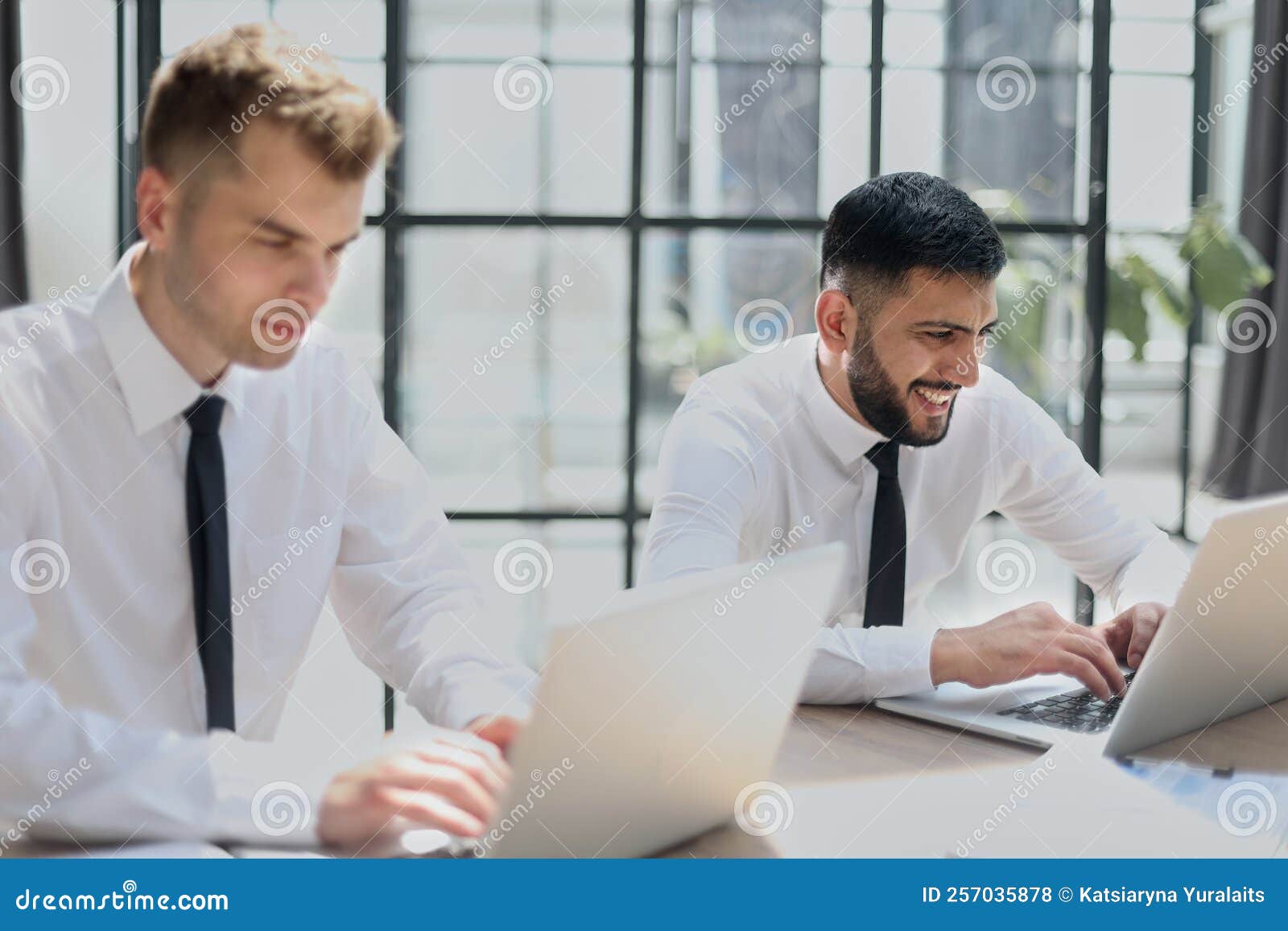 Two Happy Men Working Together on a New Business Project Stock Photo ...