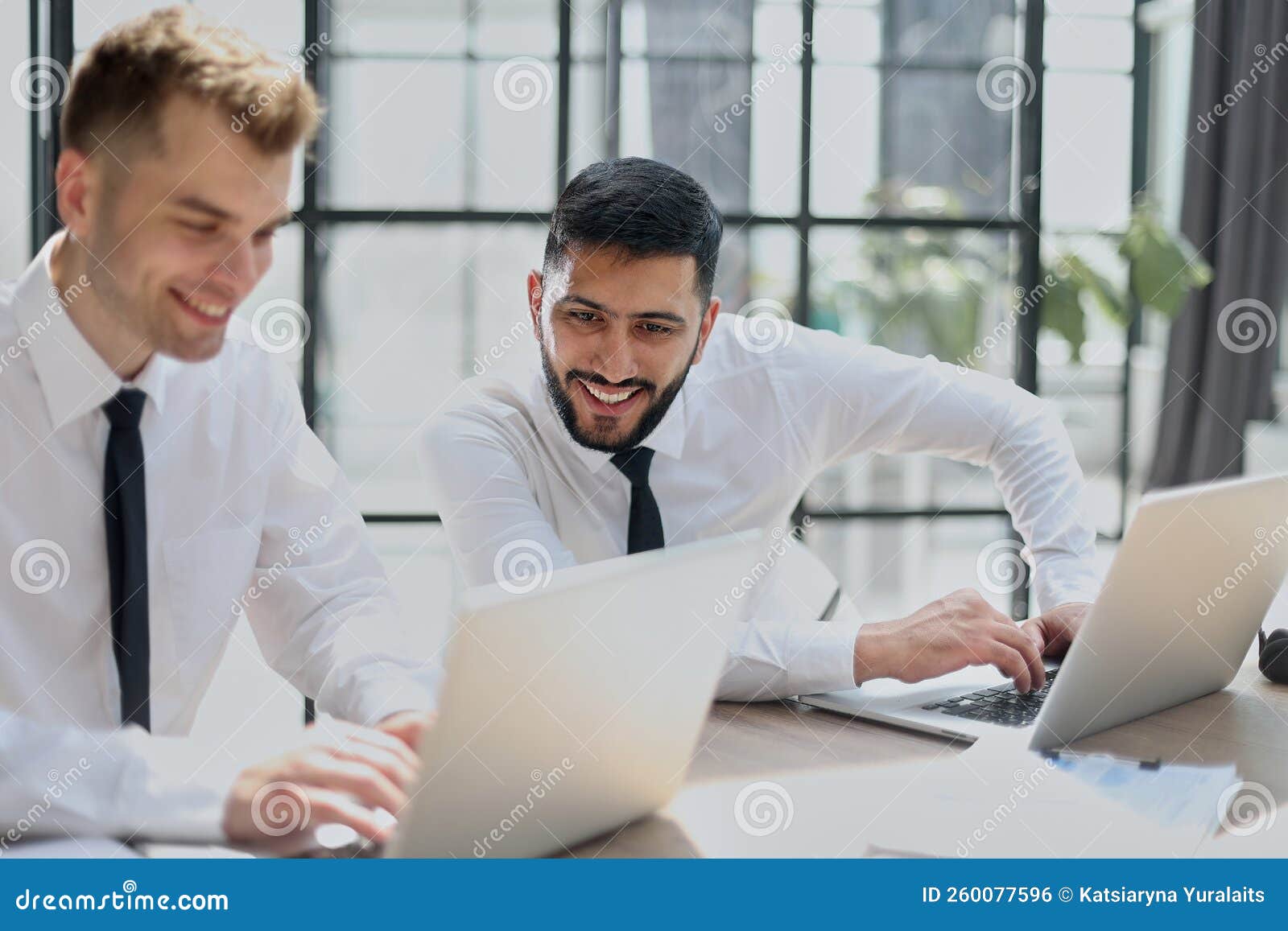 Two Happy Men Working Together on a New Business Project Stock Photo ...
