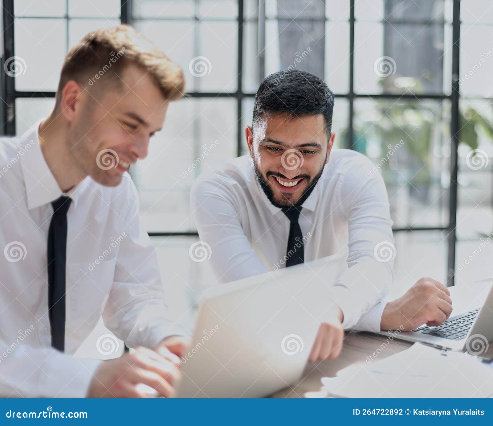 Two Happy Men Working Together on a New Business Project Stock Photo ...