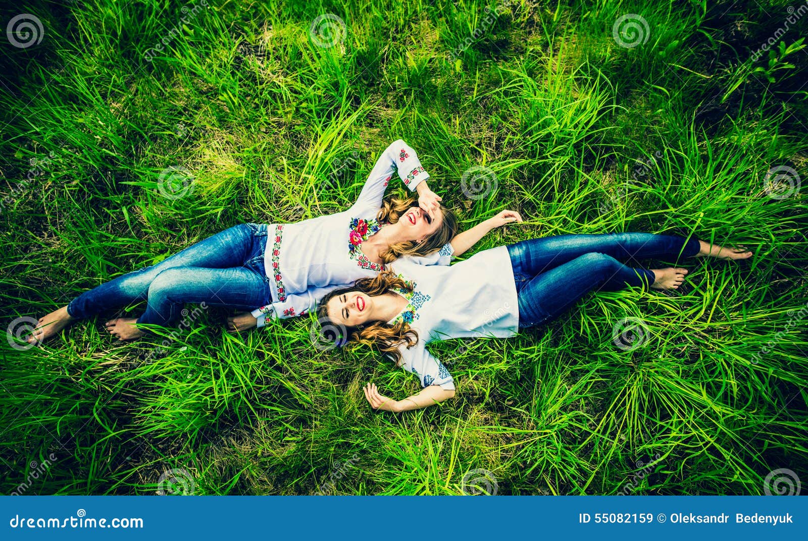 Two Happy Pretty Girls Lying On The Green Grass Stock Image Image Of