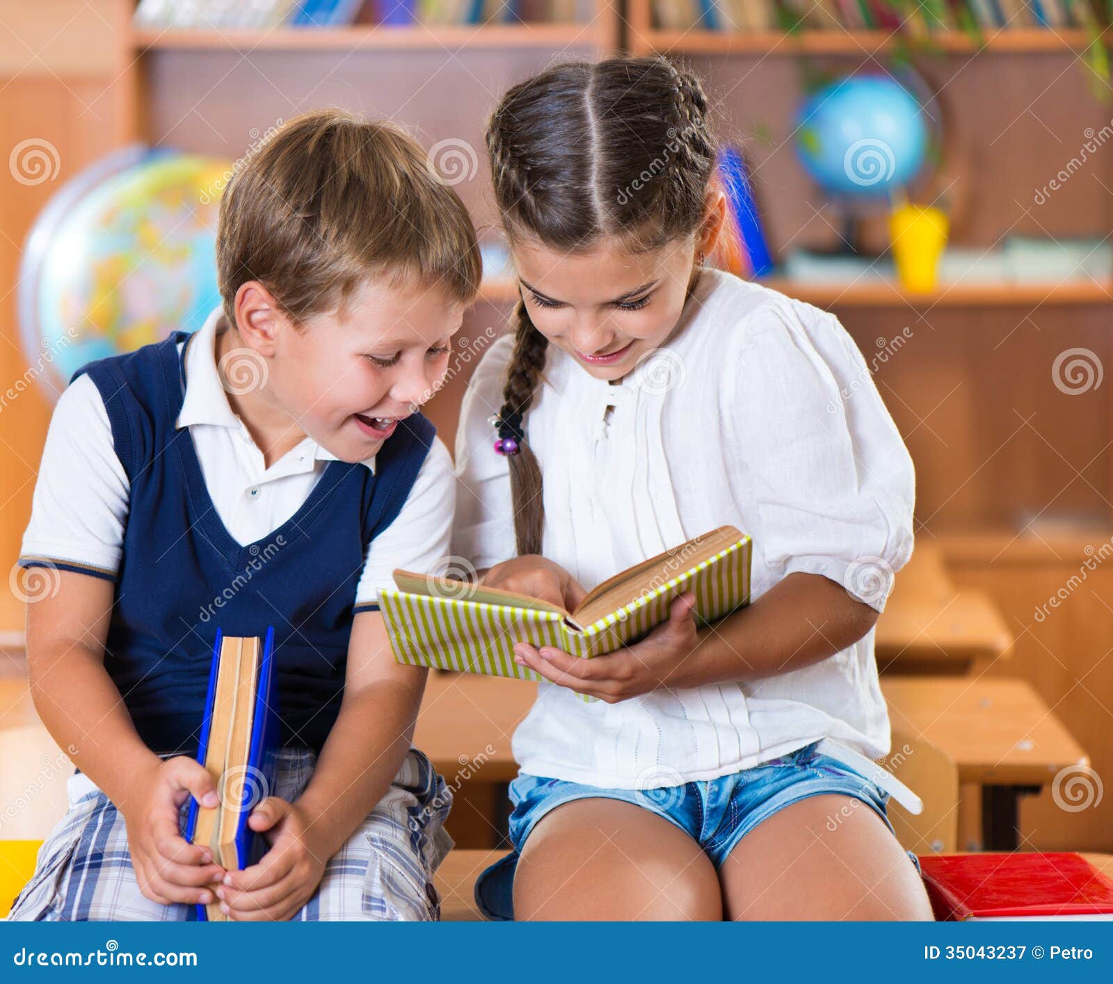 Two Happy Schoolchildren Have Fun In Classroom Royalty Free Stock ...