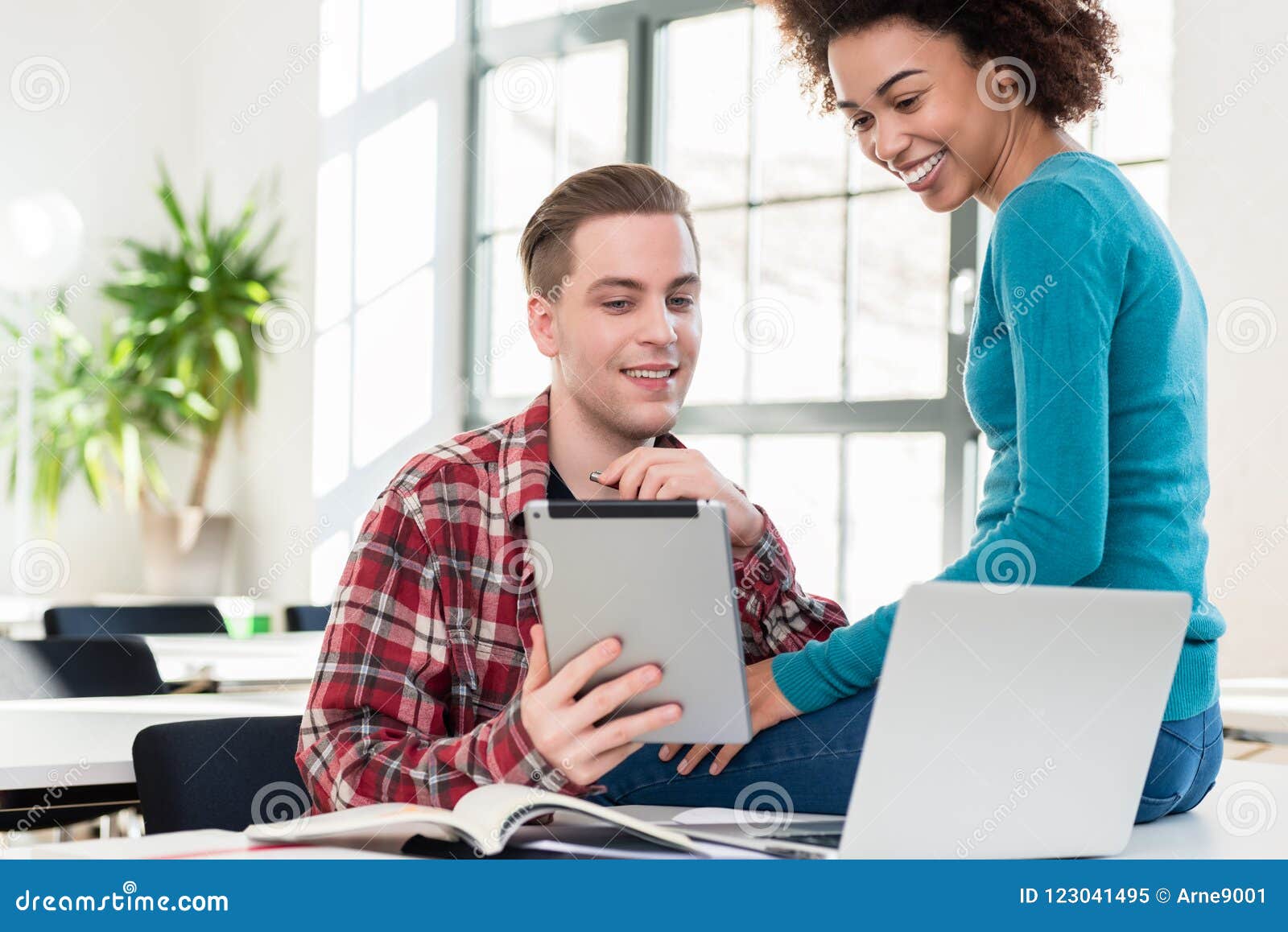 Two Happy Students Watching a Funny Video on a Tablet PC Stock Image ...