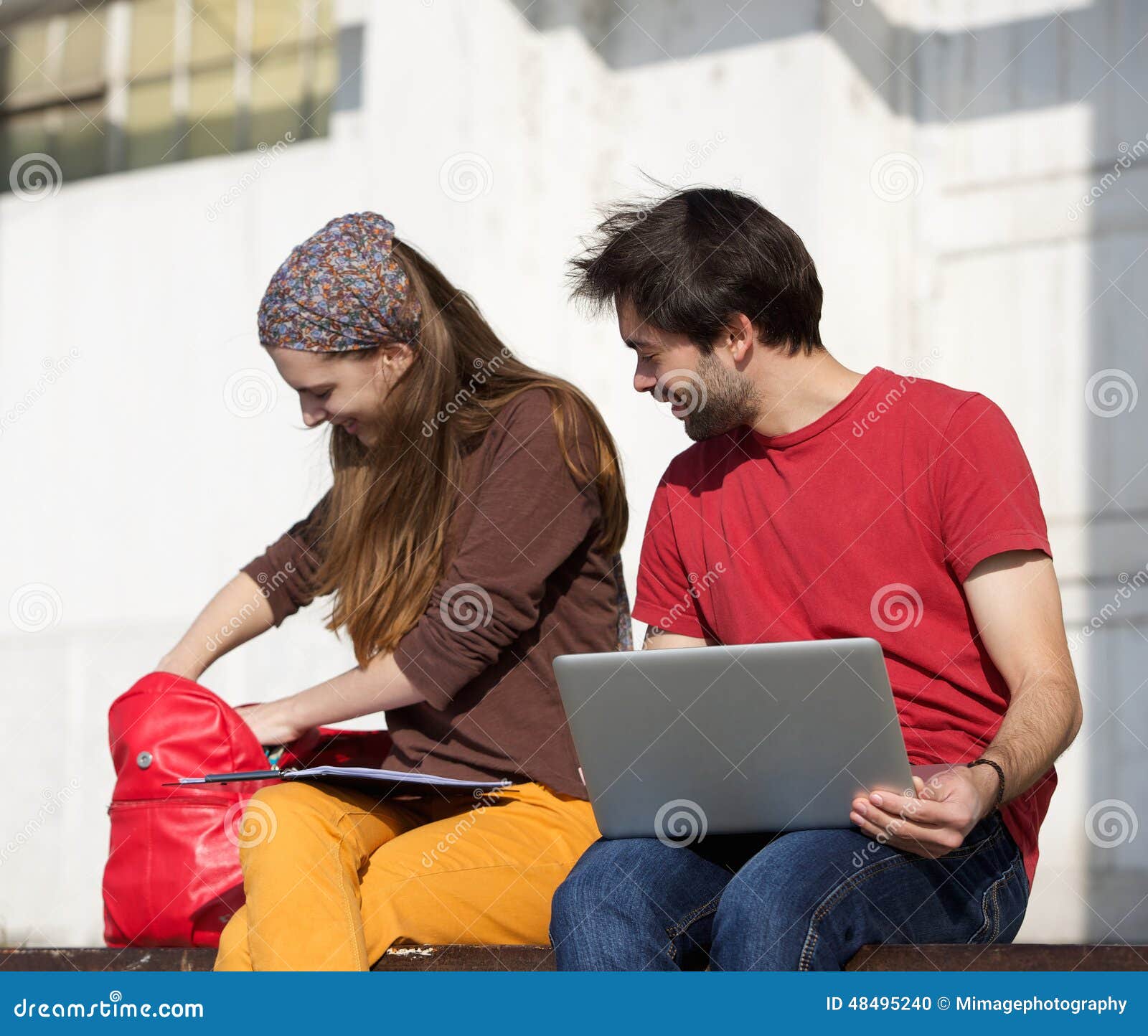 Two Happy Students Sitting Outdoors with Lap Top Computer Stock Photo ...
