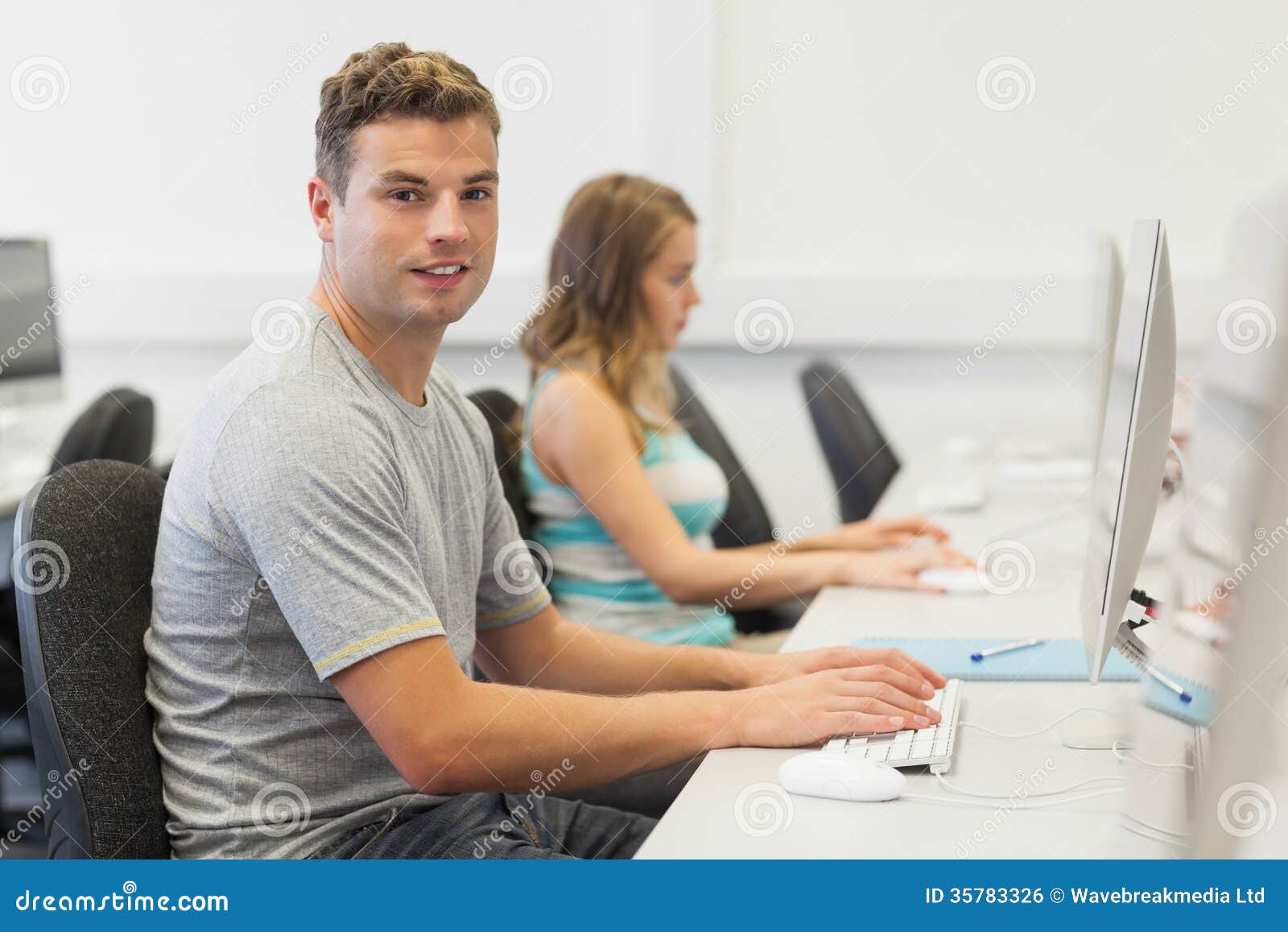 Two Happy Students Working on Computer Individually Stock Photo - Image ...