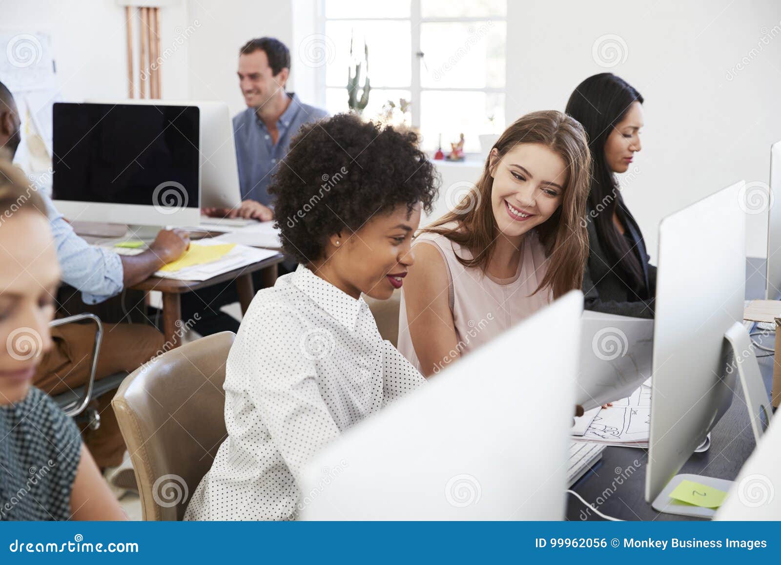 Two Happy Women Discuss Work at Computer in Open Plan Office Stock ...