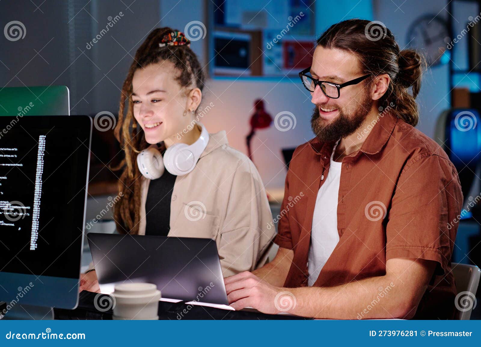 Two Happy Young it Managers Sitting by Workplace in Front of Computer ...