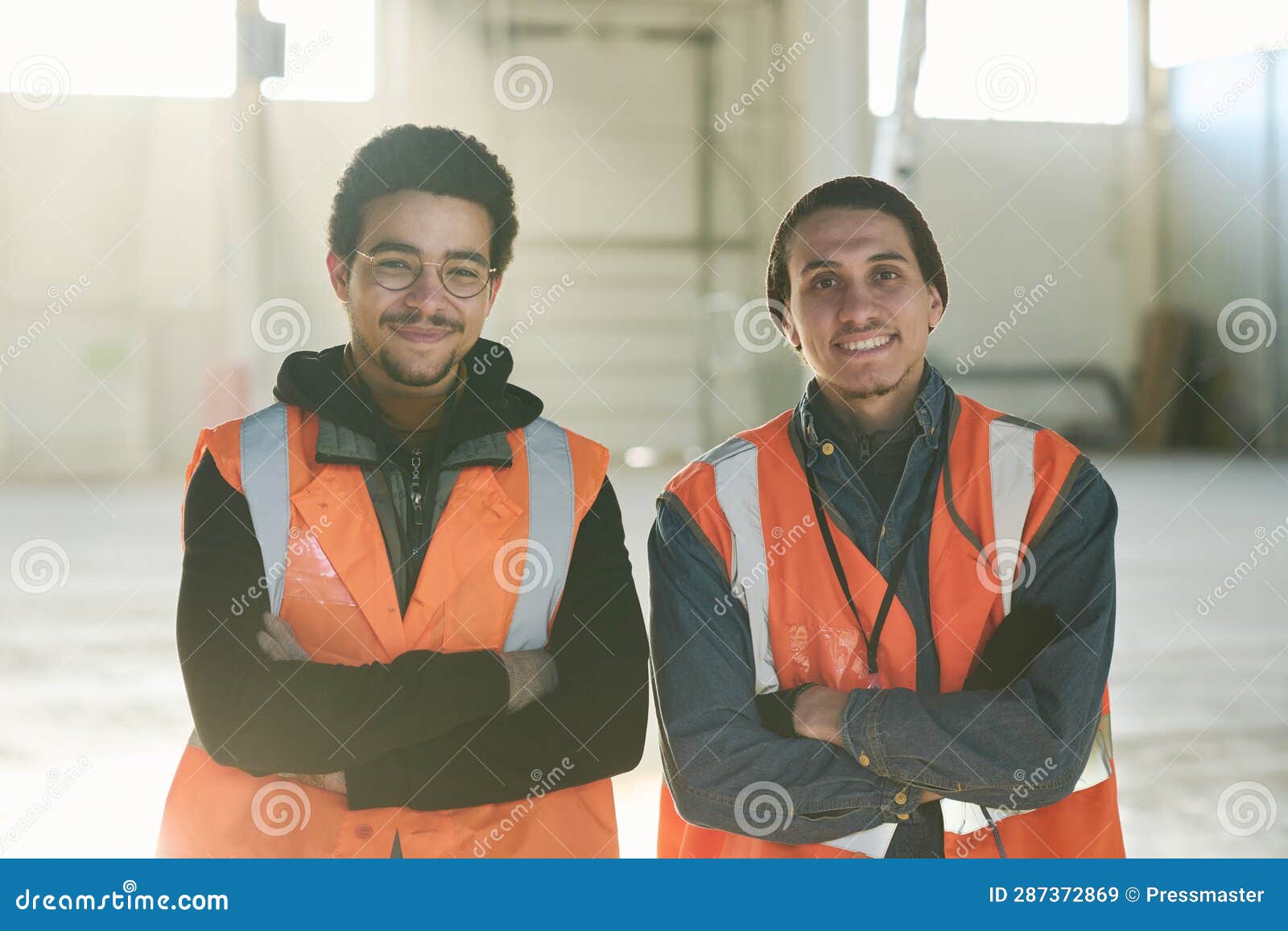 Two Happy Young Multietnic Foremen or Workers of Warehouse in Safety ...