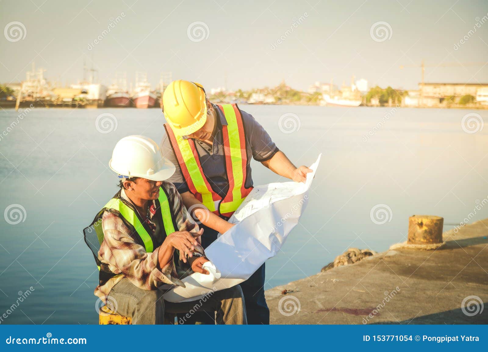 Engineers and Technicians Hold Construction Paper. Talk. Stock Photo ...