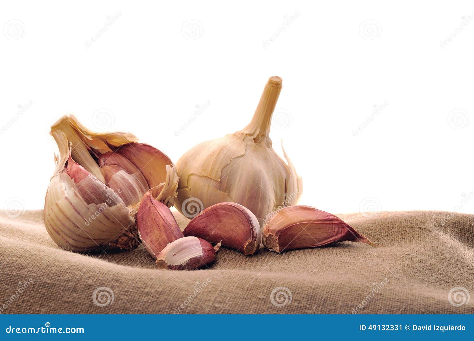 Two Heads of Garlic on Brown Fabric Stock Image - Image of brown, bulb ...