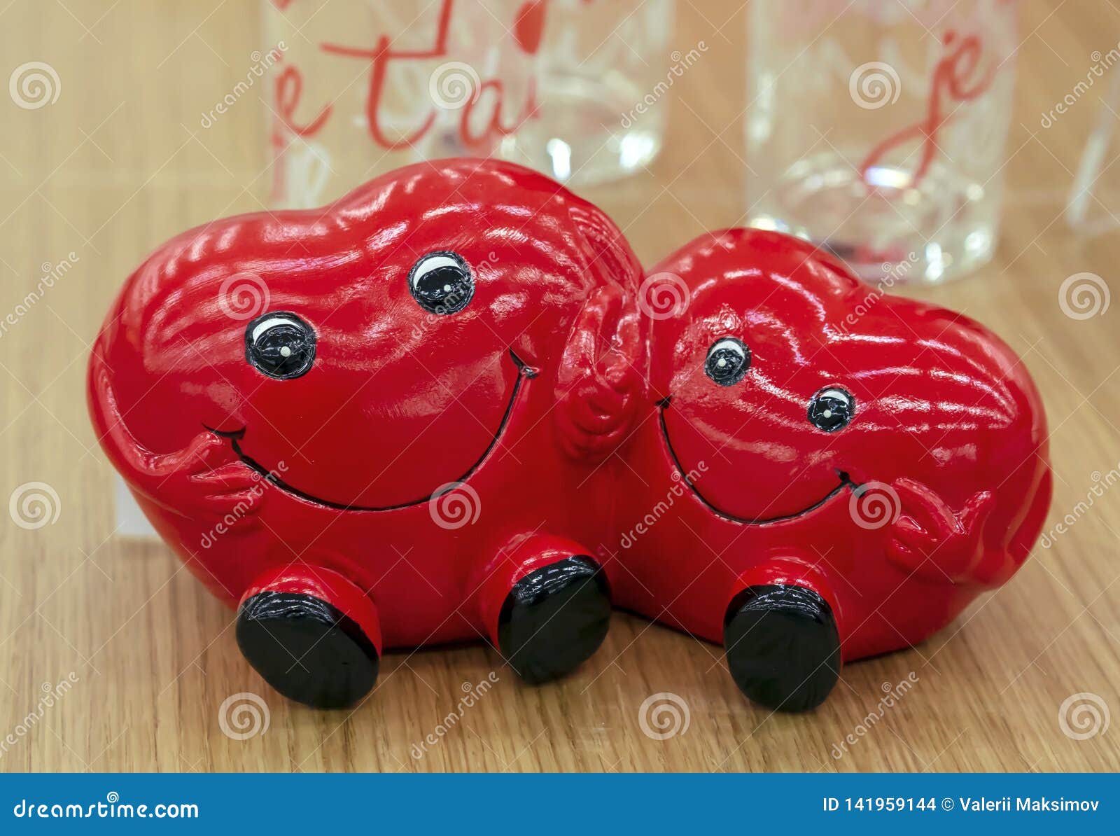 Two Hearts are Smiling and Holding Hands. Ceramic Figurine of Two ...