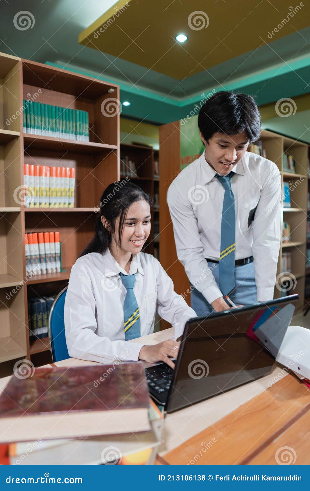 Two High School Students Chat by Studying Together with a Pile of Books ...